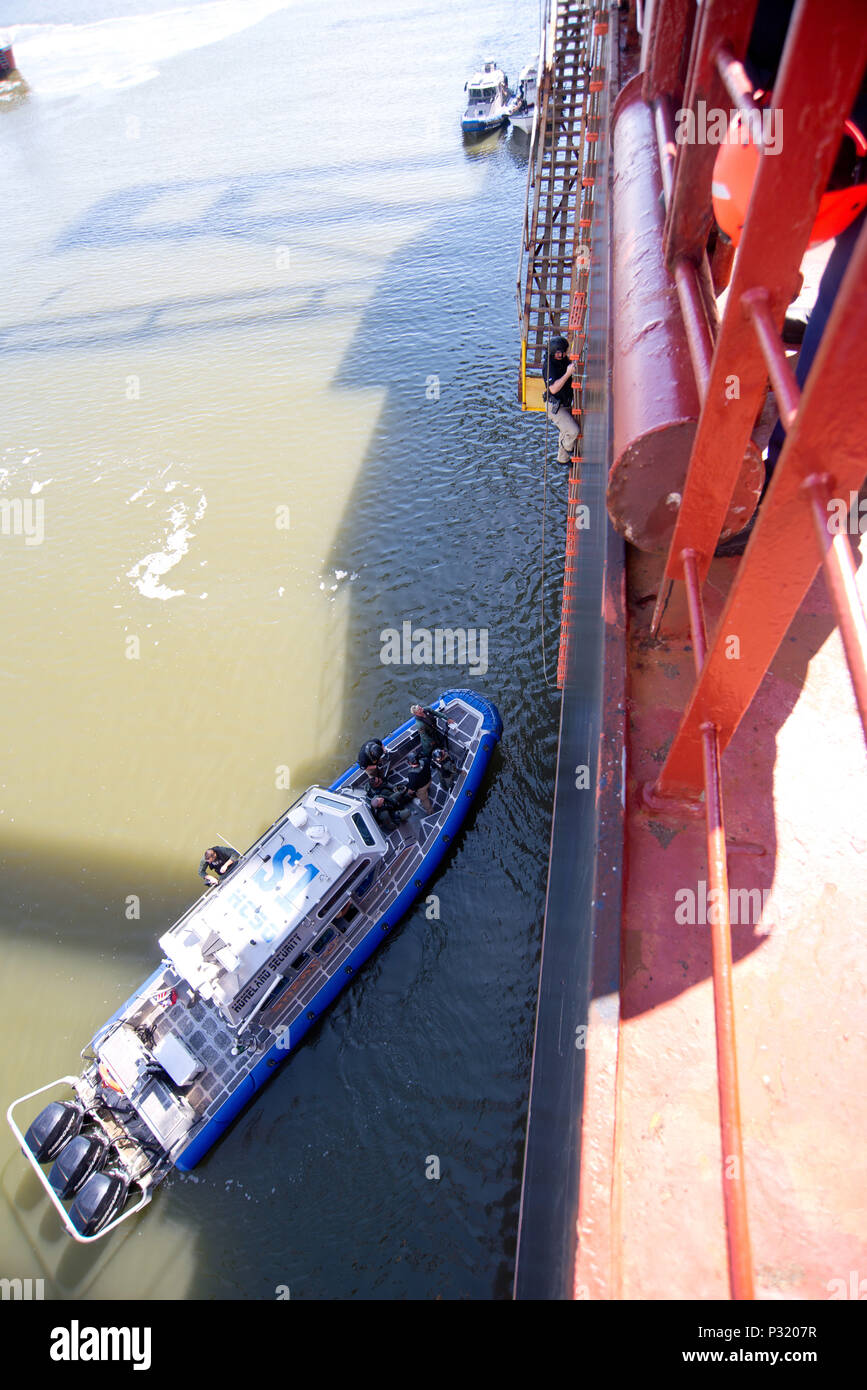 A Marine Tactical Operations Group member climbs down the side of a ...