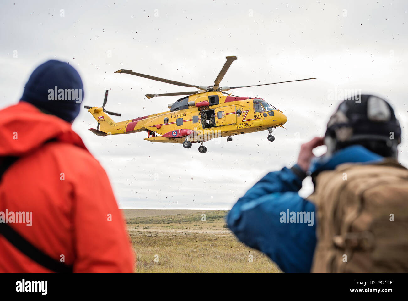 Alaska Air National Guard and Royal Canadian Air Force search and rescue personnel wait for a ...