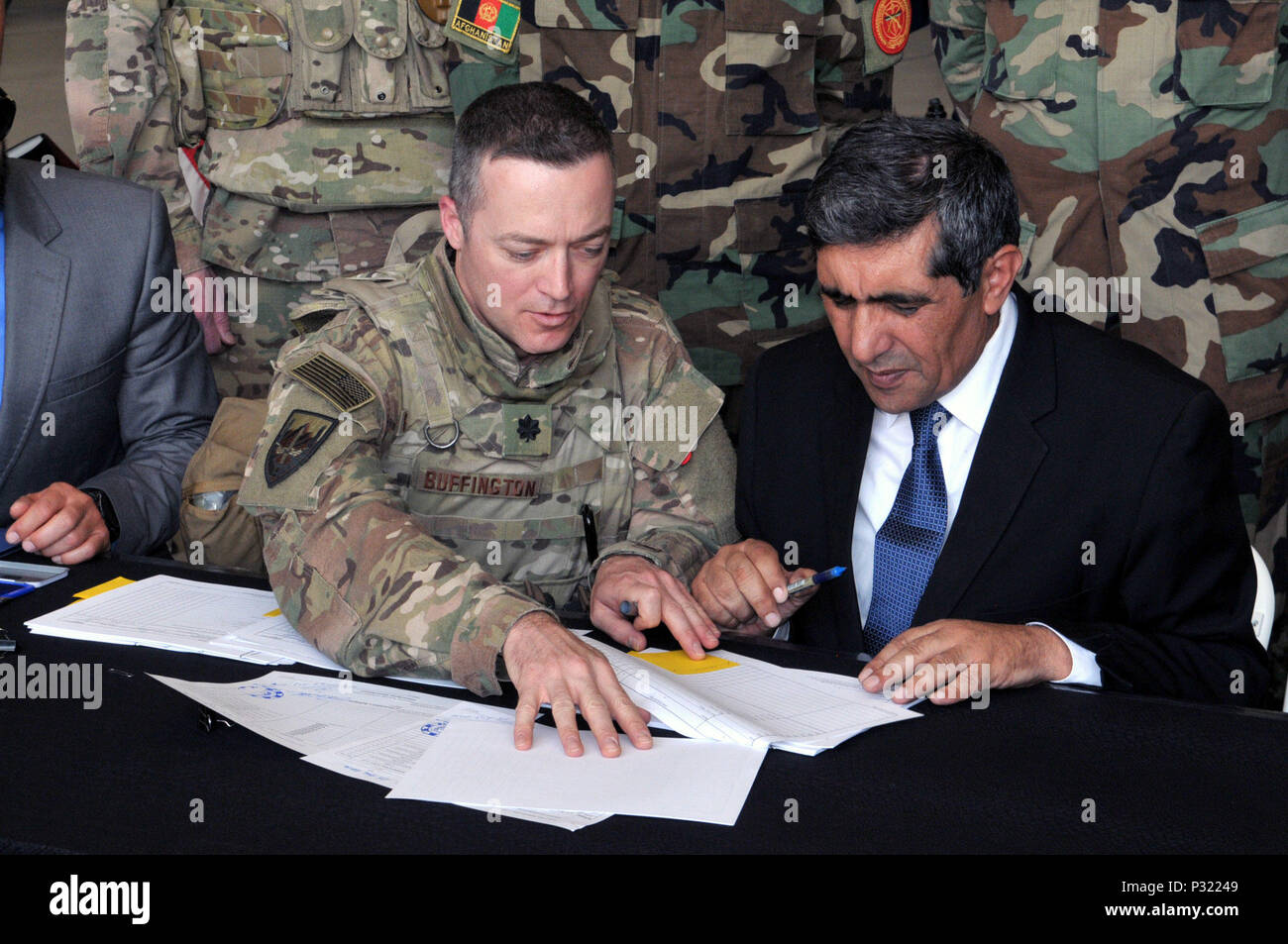 Lt. Col. Jon Buffington of CSTC-A's Security Assistance Office assists ...