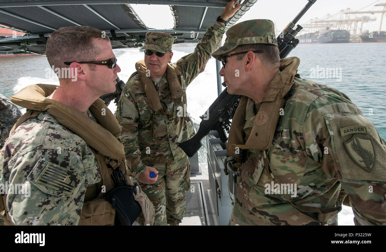 U.S. Navy Cmdr. Mark Harris, left, commanding officer of Coastal ...
