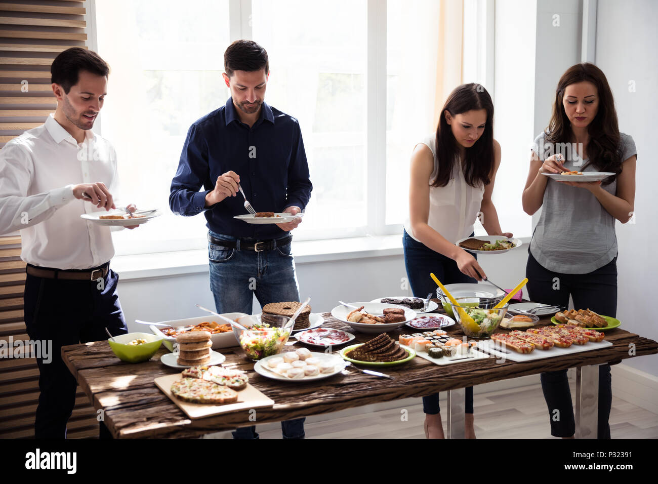 Friends Eating Healthy Food Served For Party Stock Photo - Alamy
