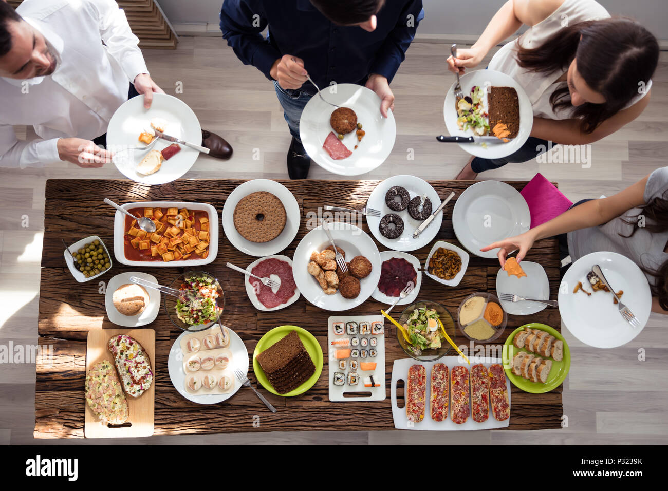Group Of People Eating Fresh Healthy Food On Plate Stock Photo - Alamy