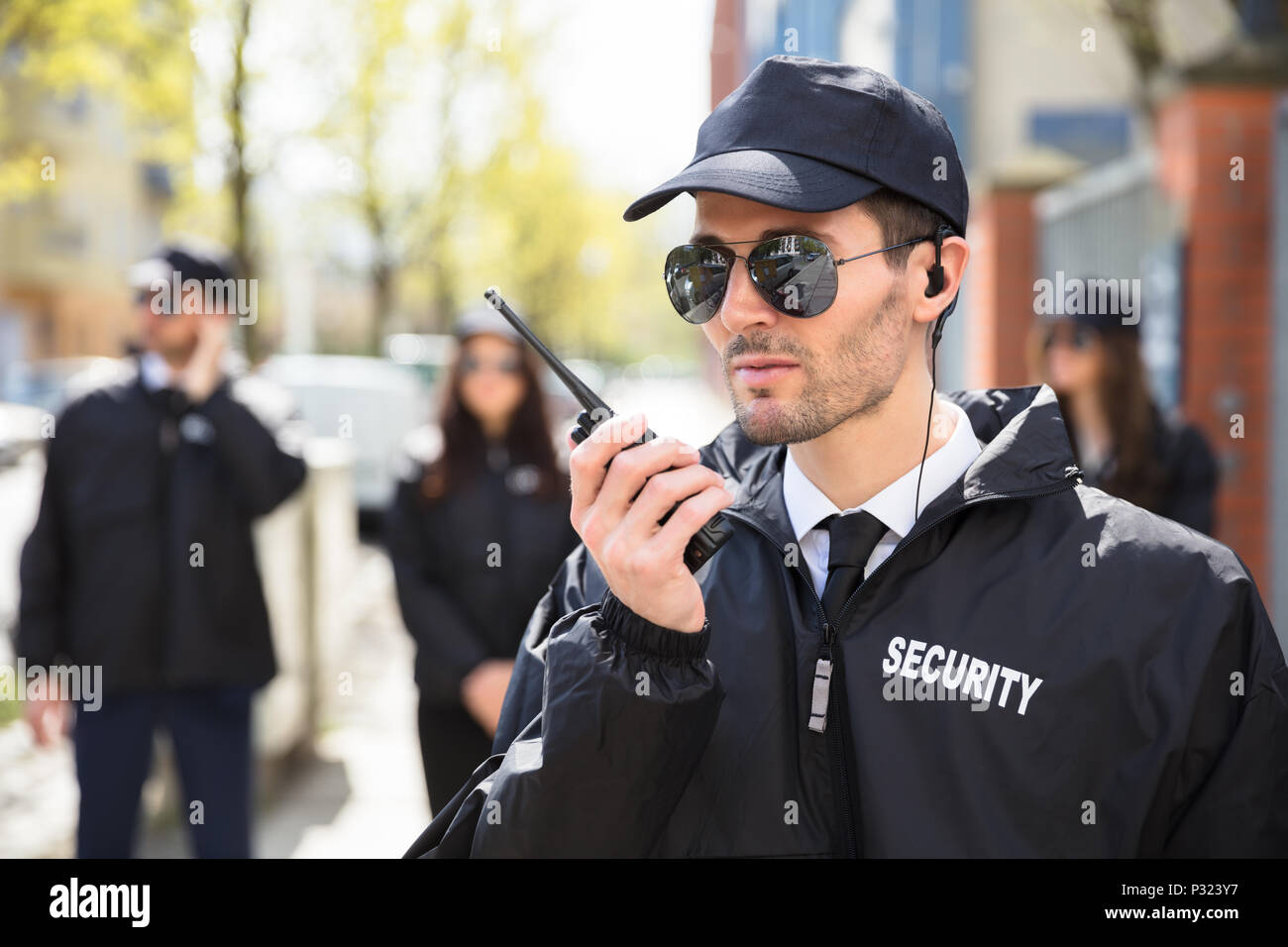 Portrait Of A Male Security Guard Talking On Walkie Talkie Stock Photo ...