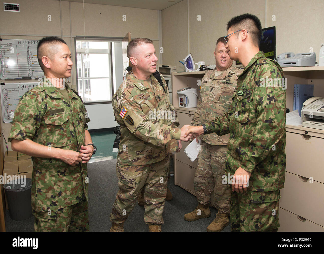U.S. Army Command Sgt. Maj. James P. Wills (left), the interim command ...