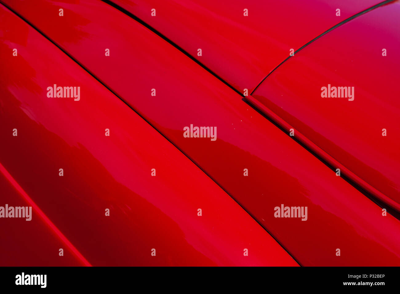 Curved lines on the rear of a restored antique car at an outdoor show ...