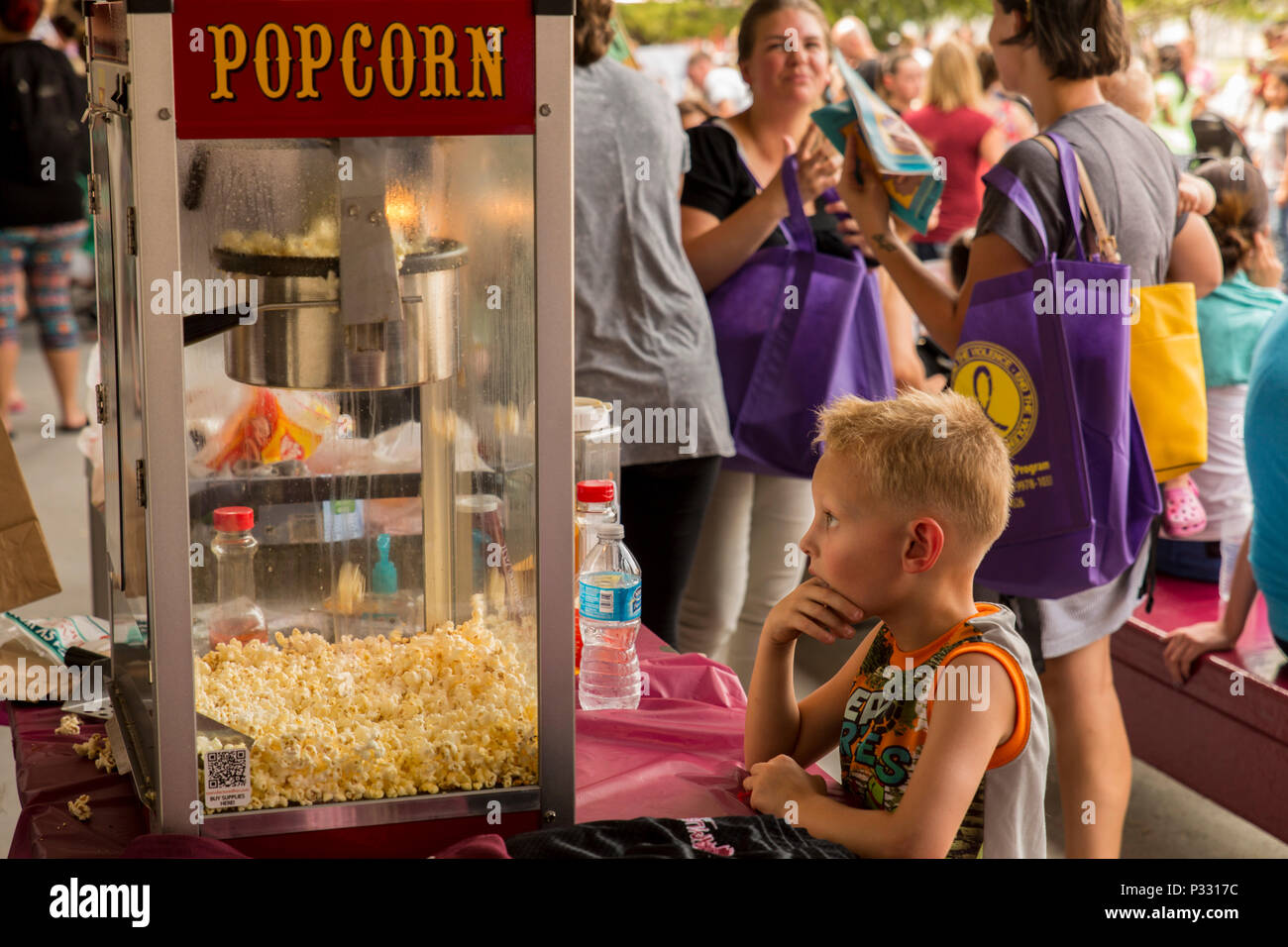 A student from Matthew C. Perry Elementary School waits for popcorn ...