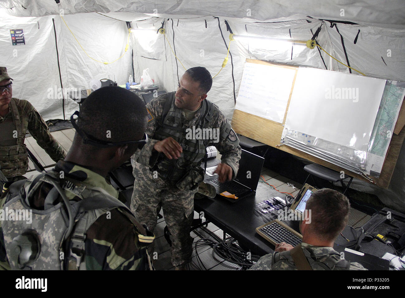 U.S. Army Staff Sgt. Khalid Belkhatir (center), a translator and ...