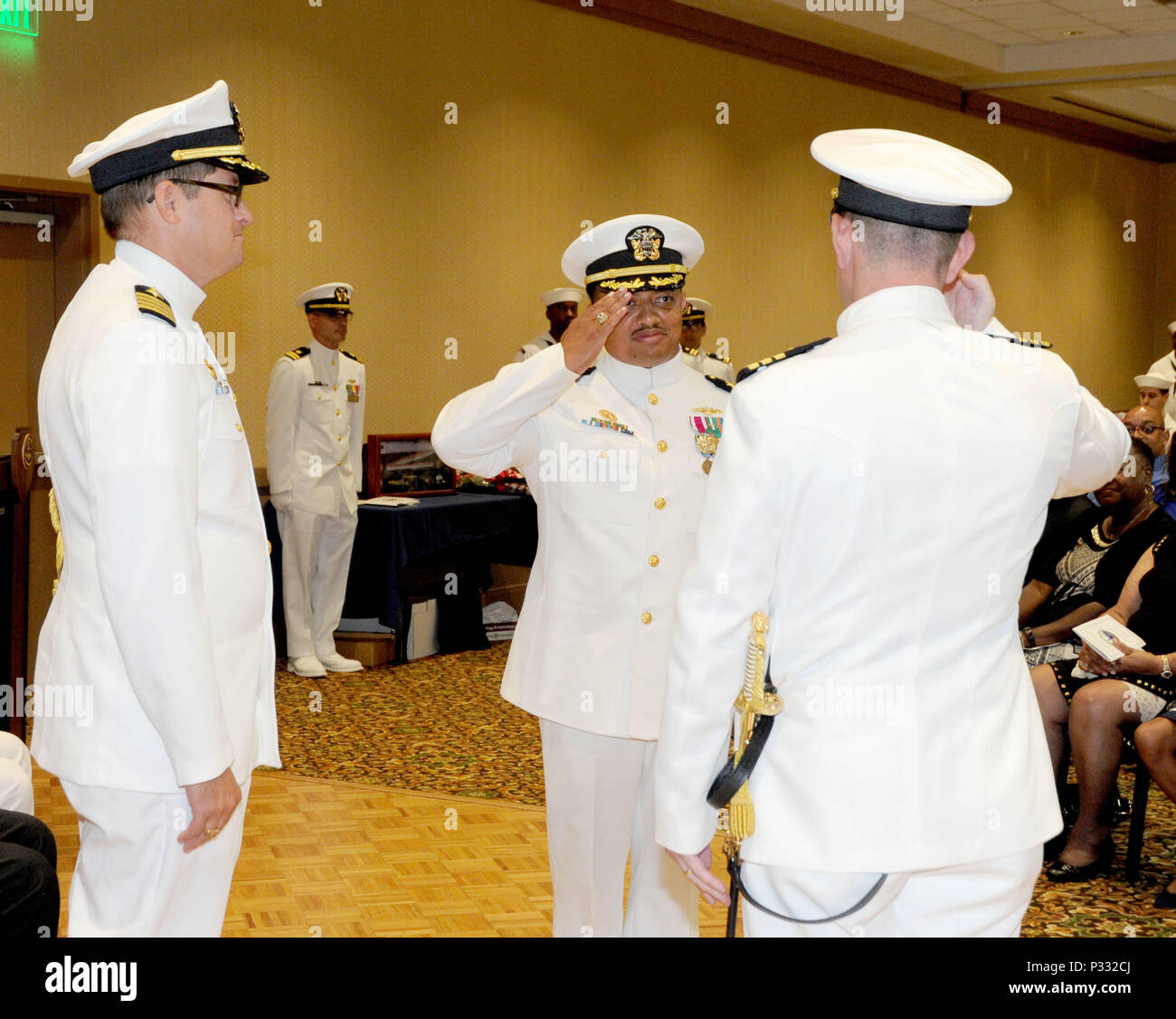Cmdr. Roy L. Wilson, center, salutes Cmdr. Robert Landis as he assumes ...
