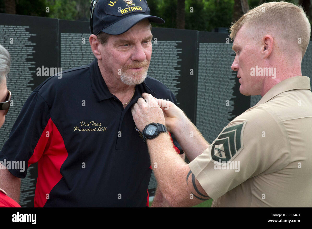 Staff Sgt. Thomas F. Stewart, Jr., (right) places a pin of honor on the ...