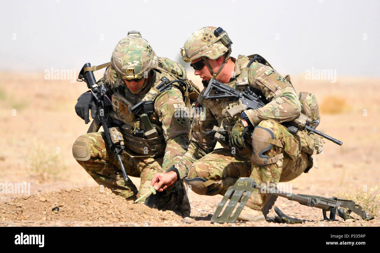 Sgt. First Class Jesse Cody and Staff Sgt. Sean Robertson investigate a ...