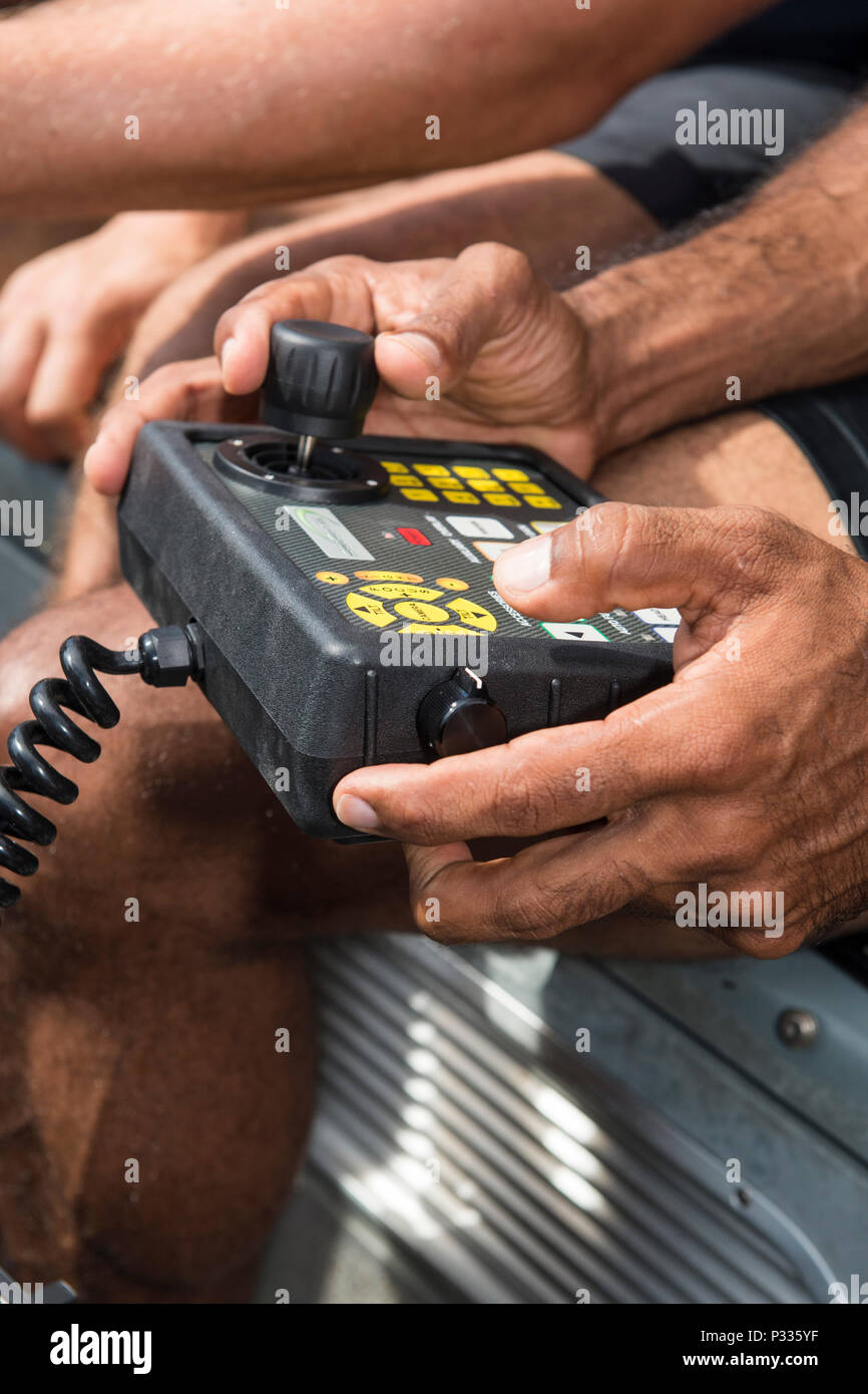 A Sri Lankan Navy diver operates a SeaBotix remotely operated vehicle ...
