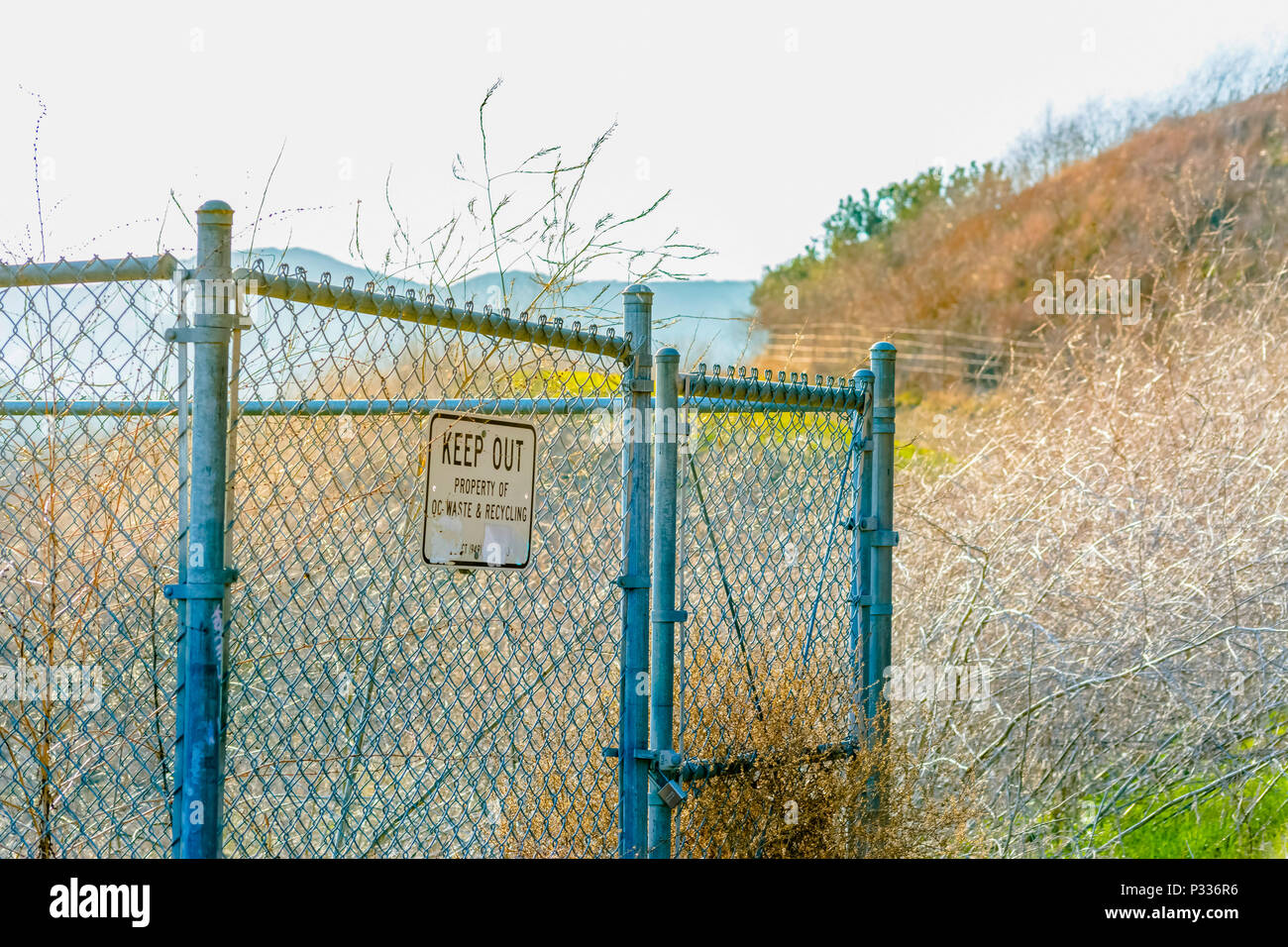 Sign saying Keep Out on fence with stickers blocking the bottom half ...