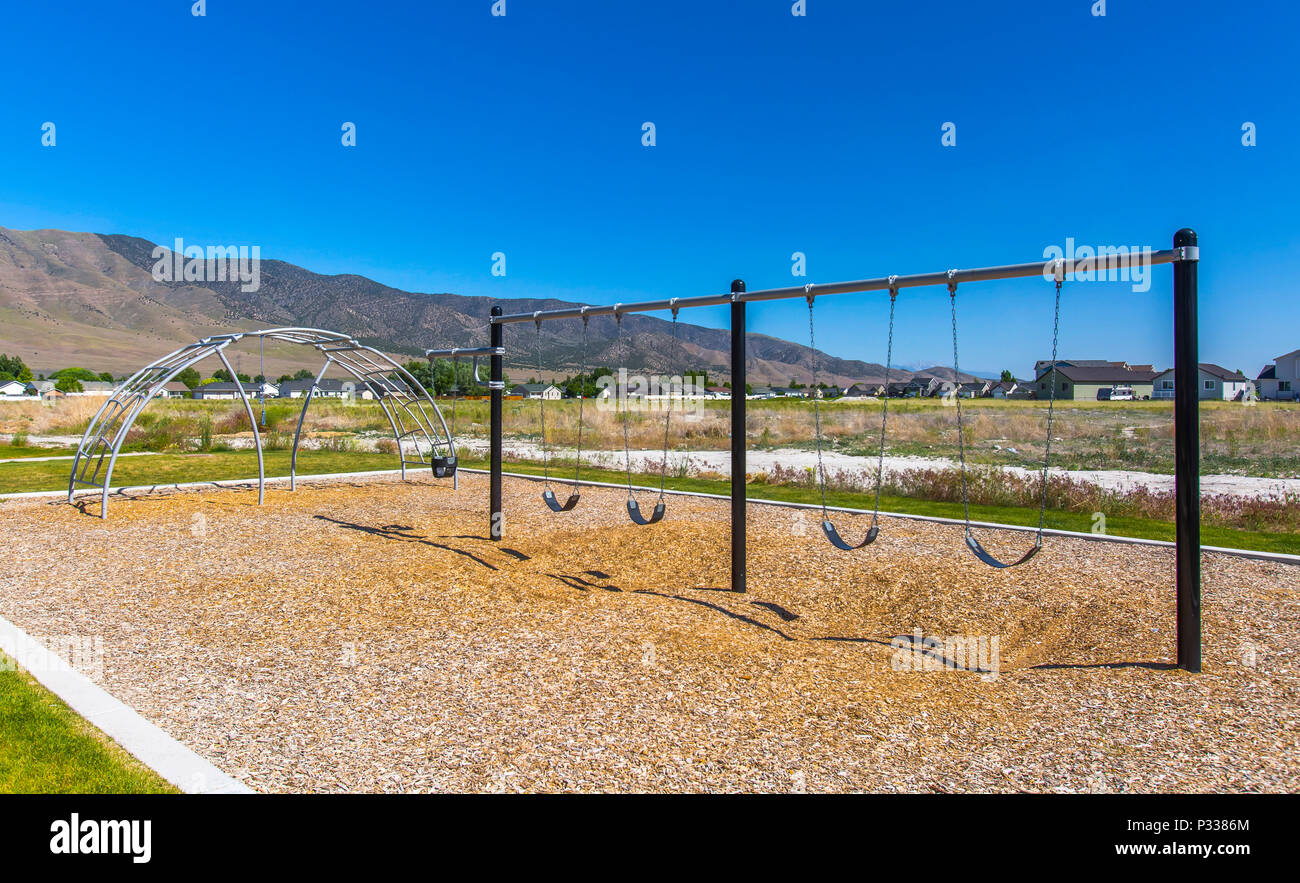 Swing set at a local playground in Utah Valley Stock Photo - Alamy