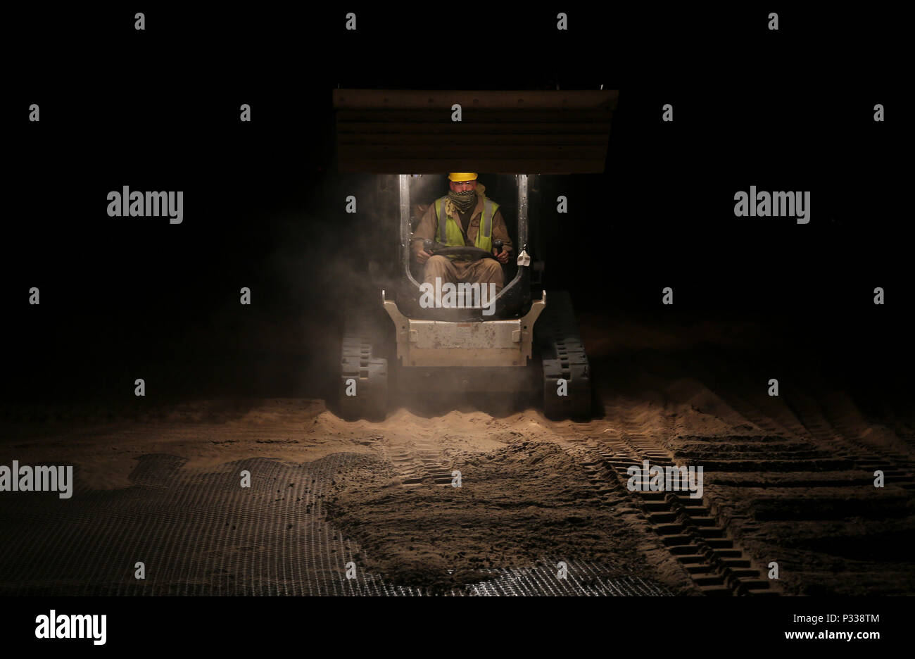 A U.S. Marine with 8th Engineer Support Battalion fills and levels ...