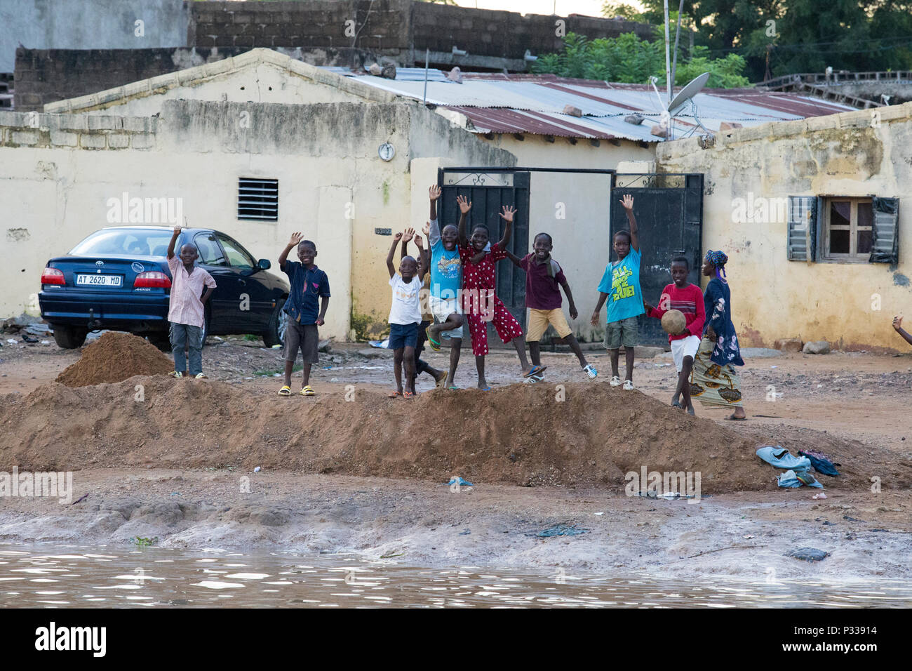 Local children wave from the banks of a village as U.S. Marines on ...
