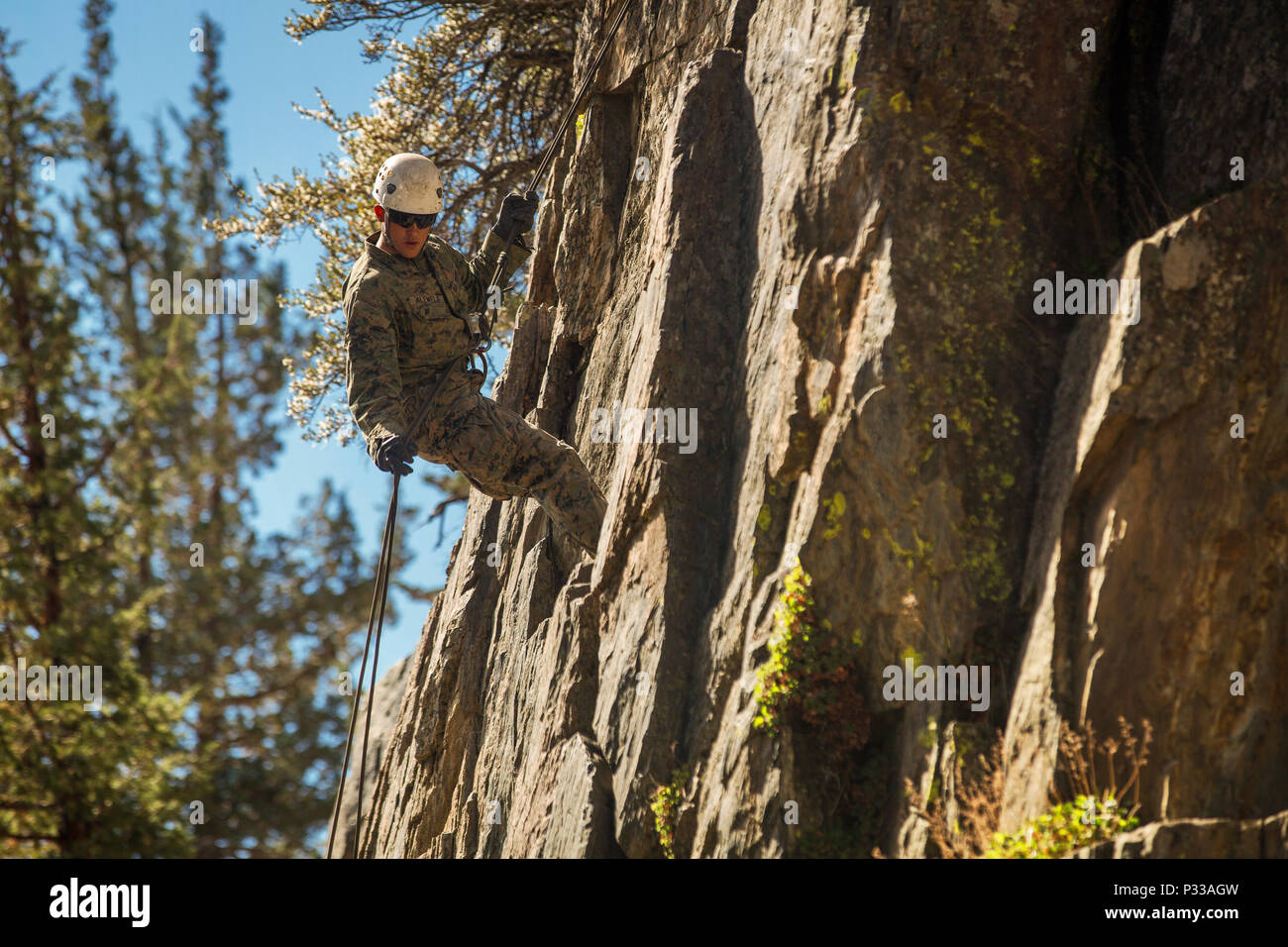 A Marine with 3rd Battalion, 8th Marine Regiment, self-belays down a ...