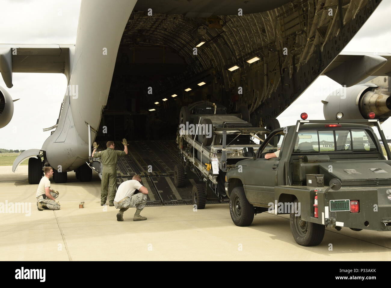 Members of the 114th Logistics Readiness Squadron load a C-17 aircraft ...