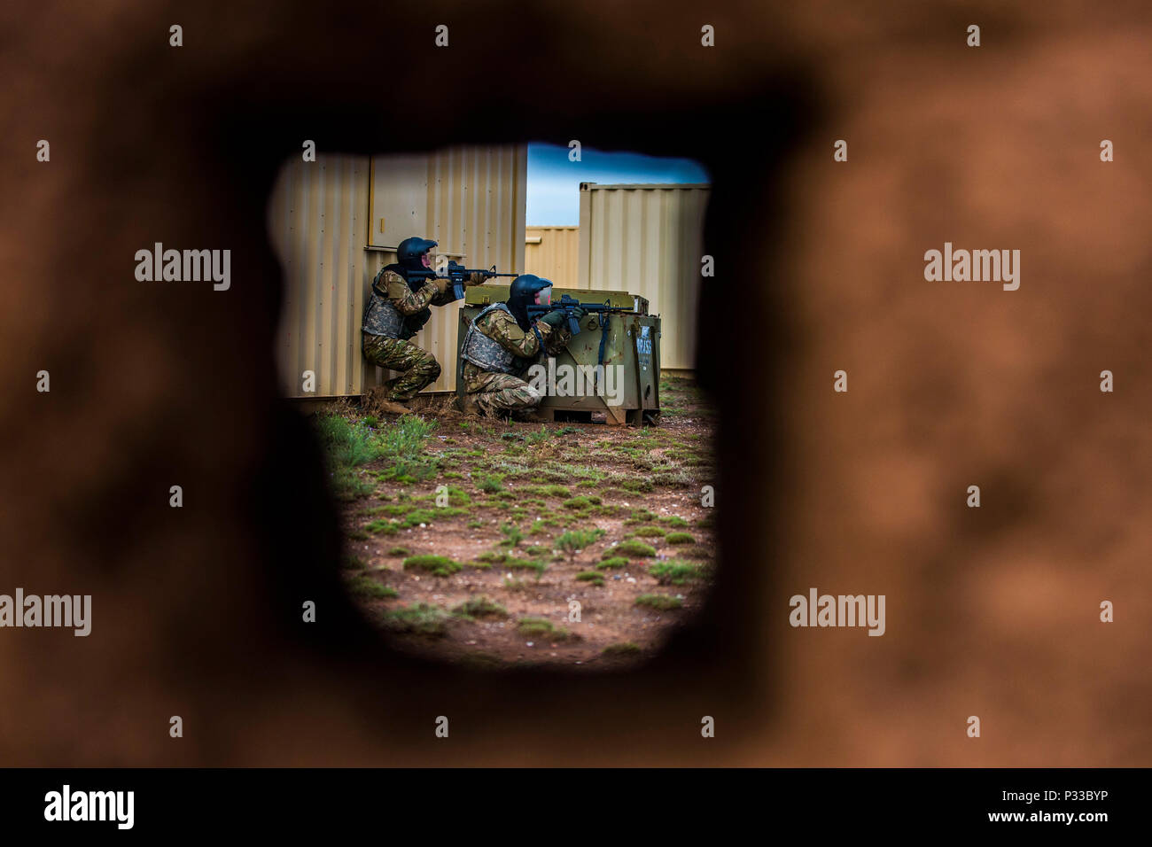 Two Air Commandos take cover behind a barrier during their ...