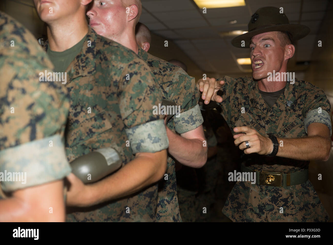 Drill Instructor Sgt. Leonard R. Webb Jr., encourages recruits of ...