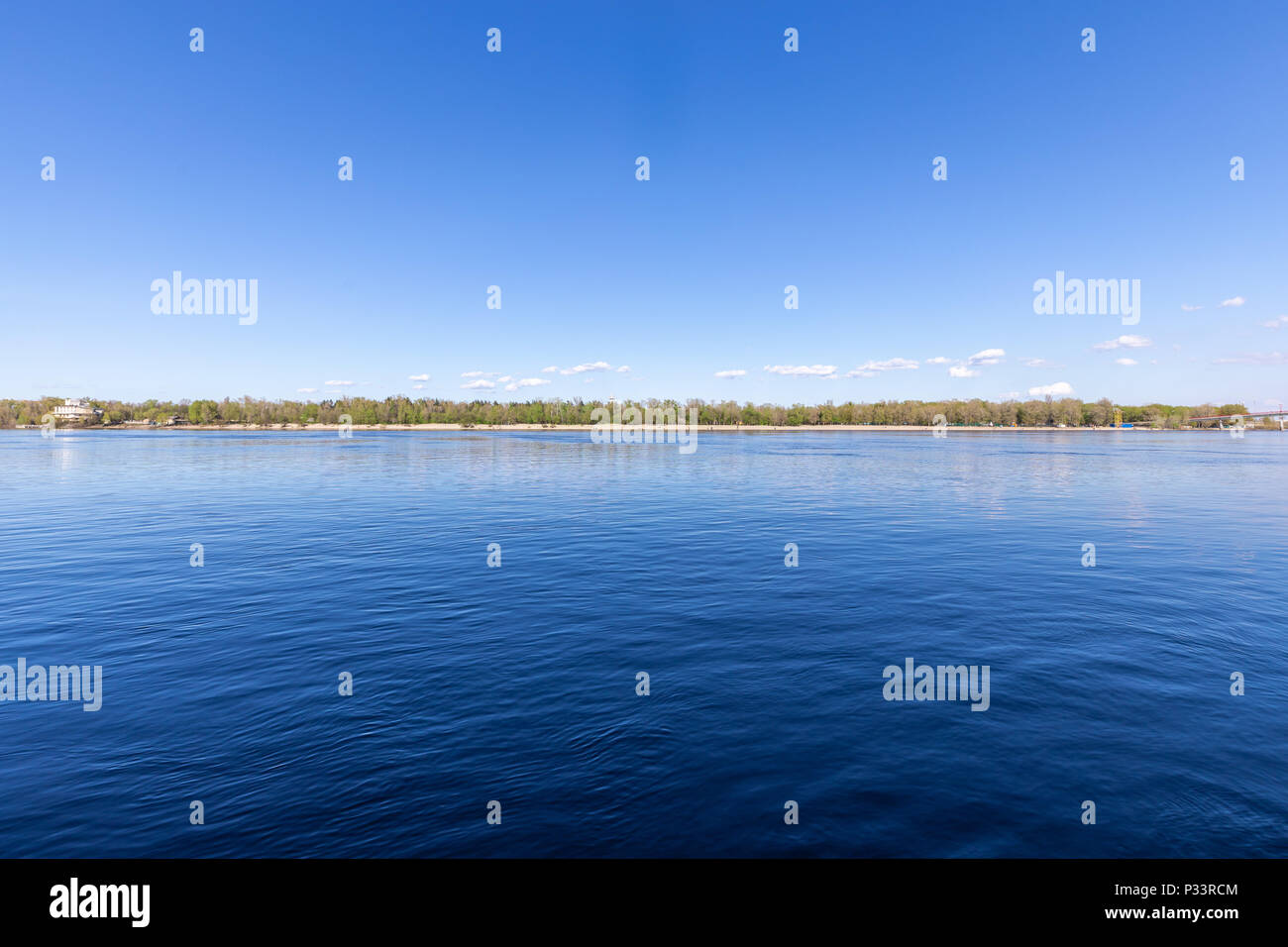View with blue river and horizon line Stock Photo - Alamy