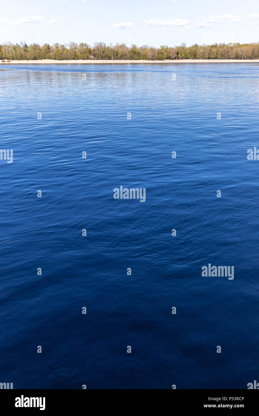 View with blue river and horizon line Stock Photo - Alamy