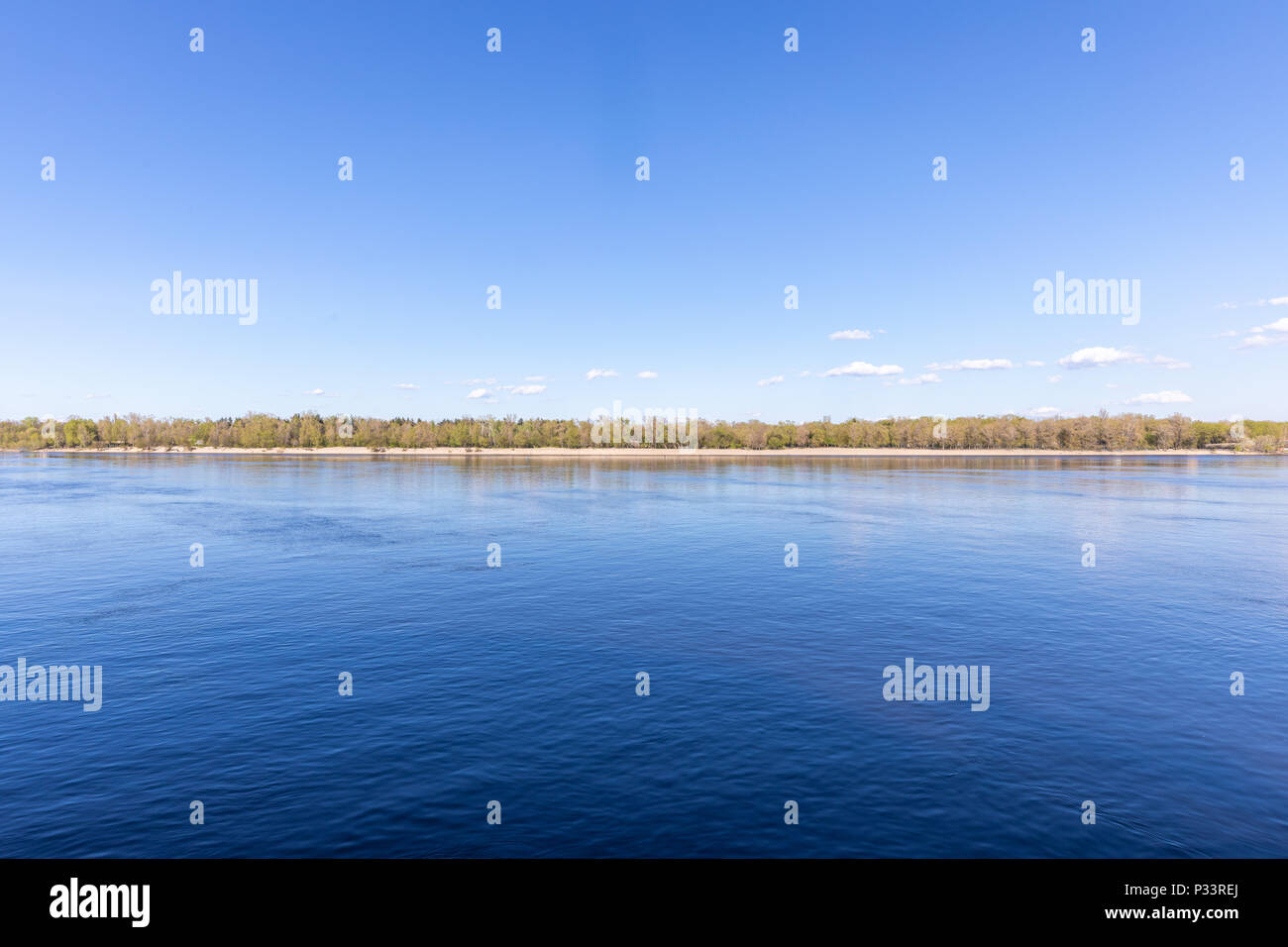 View with blue river and horizon line Stock Photo - Alamy