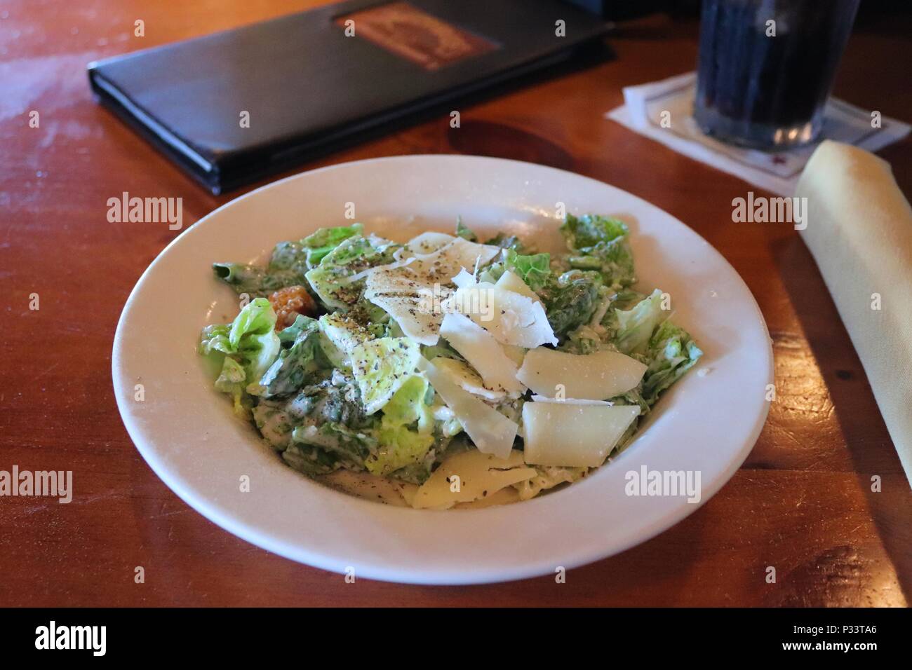 Caesar salad, served with cold coke soft drink and menu in a Texan ...