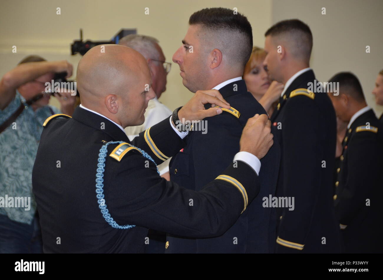 Friends, family and fellow military members watch as members of ...