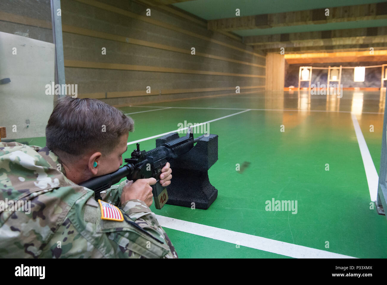 A bullet casing flies off his M4A1 carbine as U.S. Army Staff Sgt. Sean ...