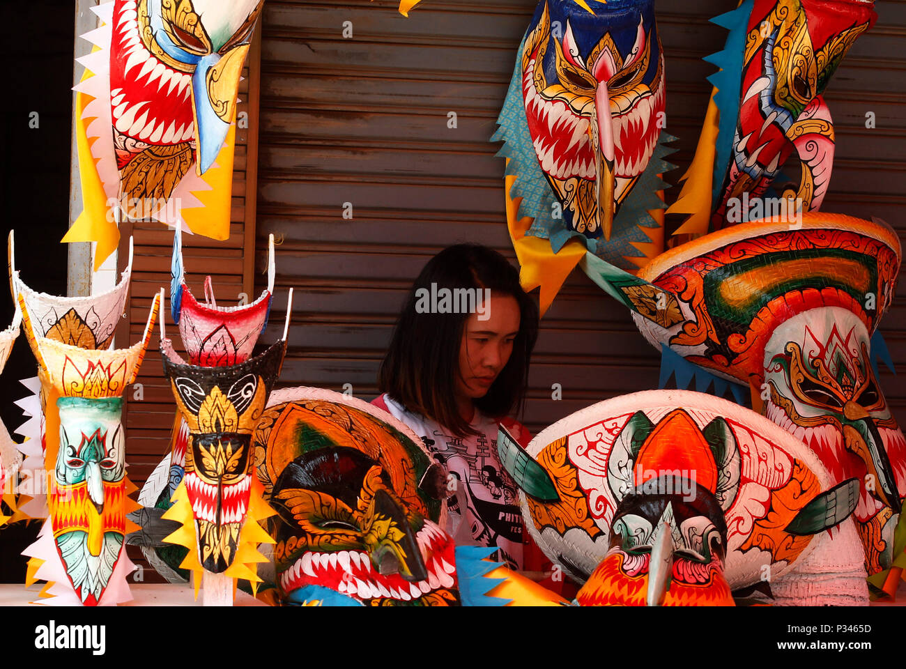 Thailand. 16th June, 2018. A vender wear a mask representing the ...