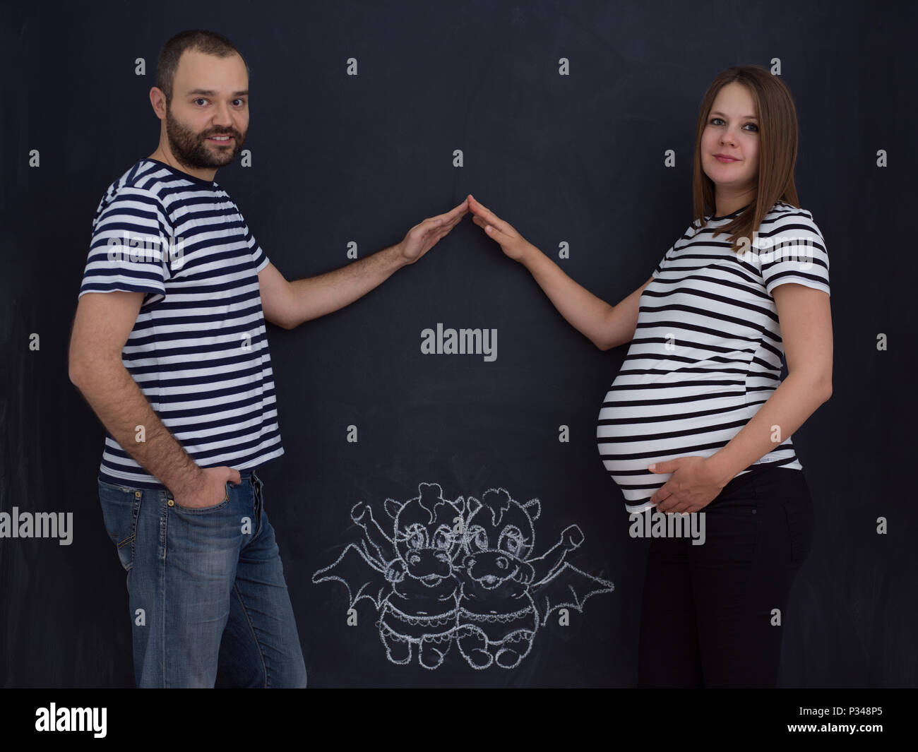 Conceptual photo of pregnant couple drawing their imaginations about ...