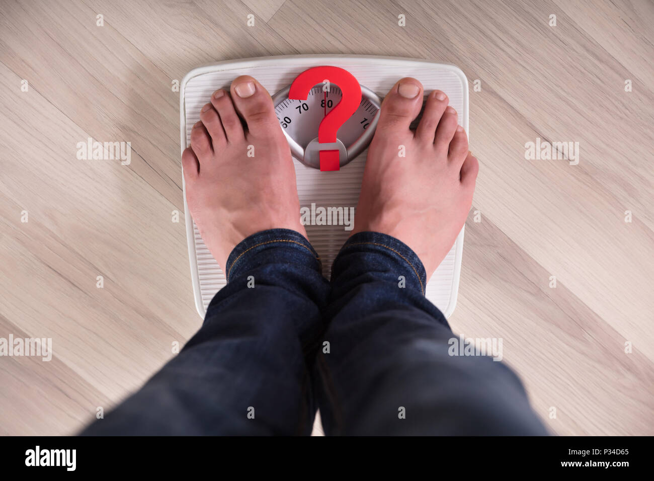 Overweight man standing on scale hi-res stock photography and images ...