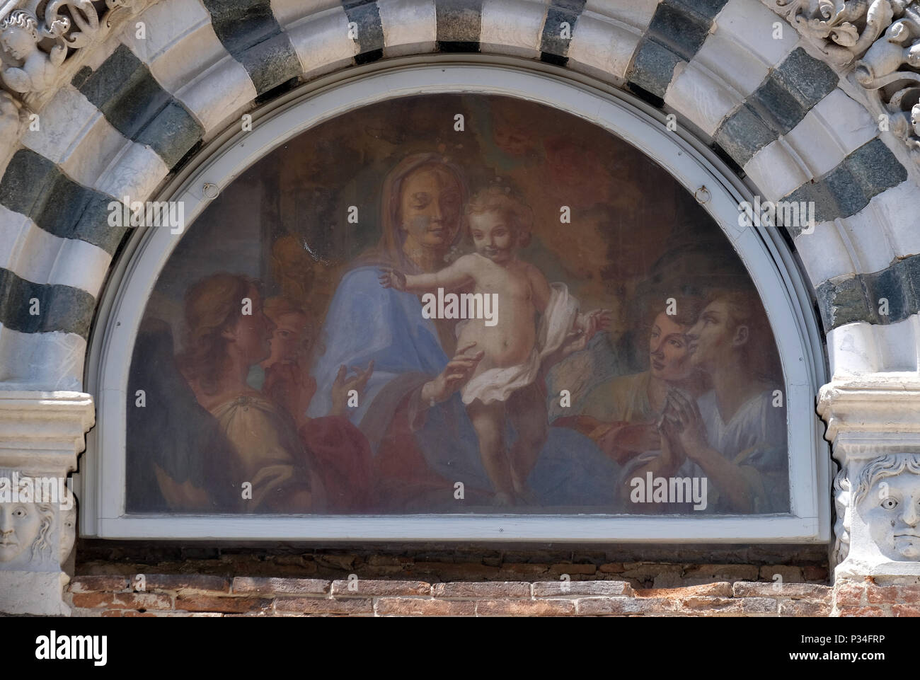 Virgin Mary with baby Jesus, lunette on the portal of San Giusto church ...