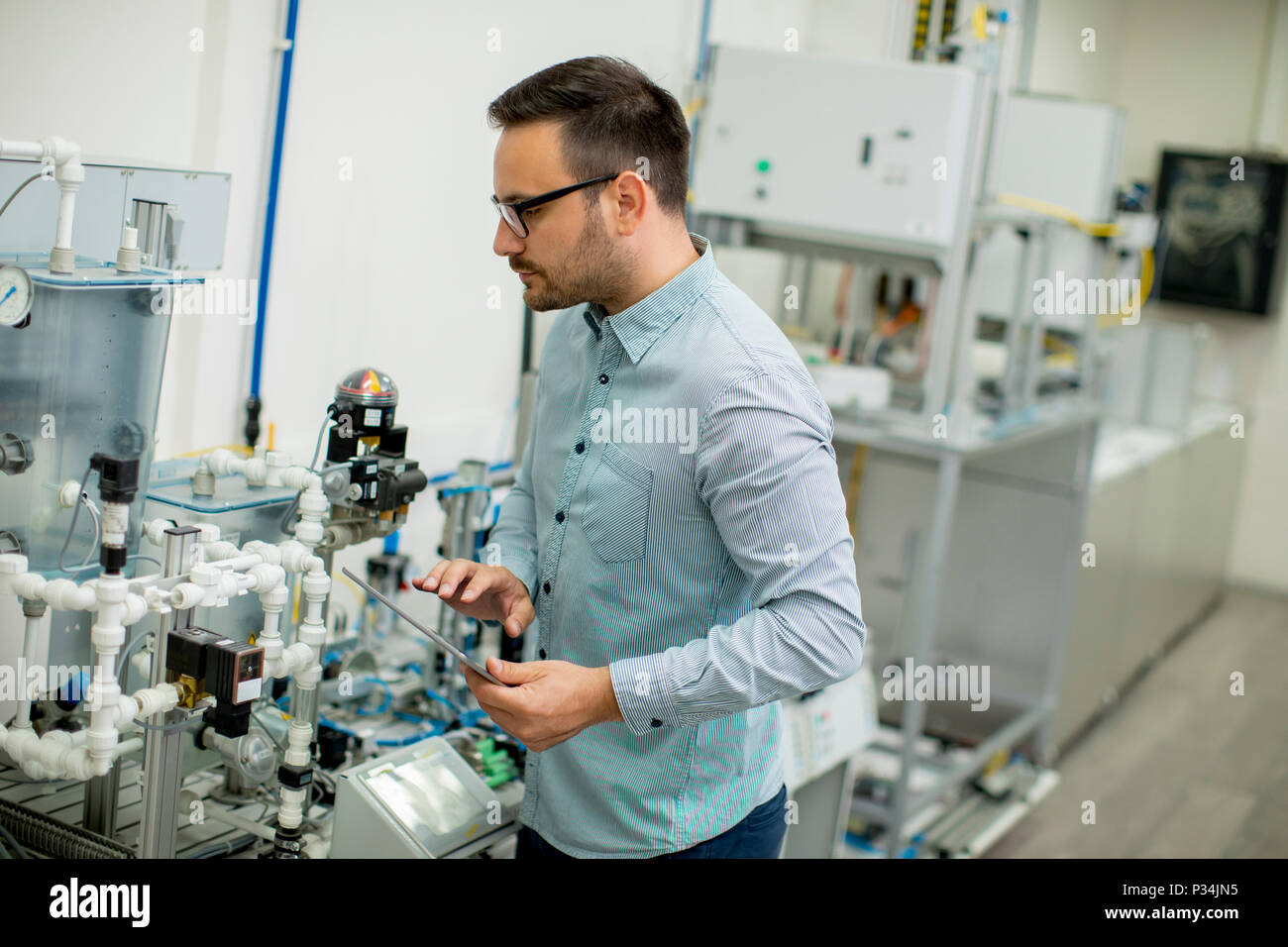 Handsome young man in the electronic workshop Stock Photo - Alamy