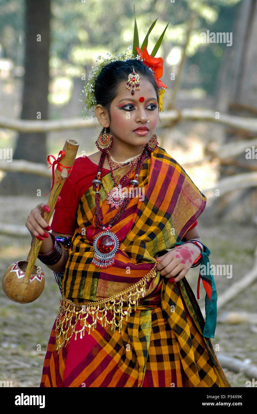 Girl holding an 'ektara', a traditional musical instrument, and ...
