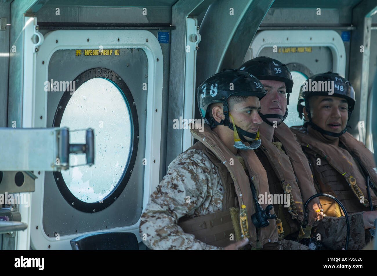 Marines with 3rd Battalion, 5th Marine Regiment, sit inside of the ...