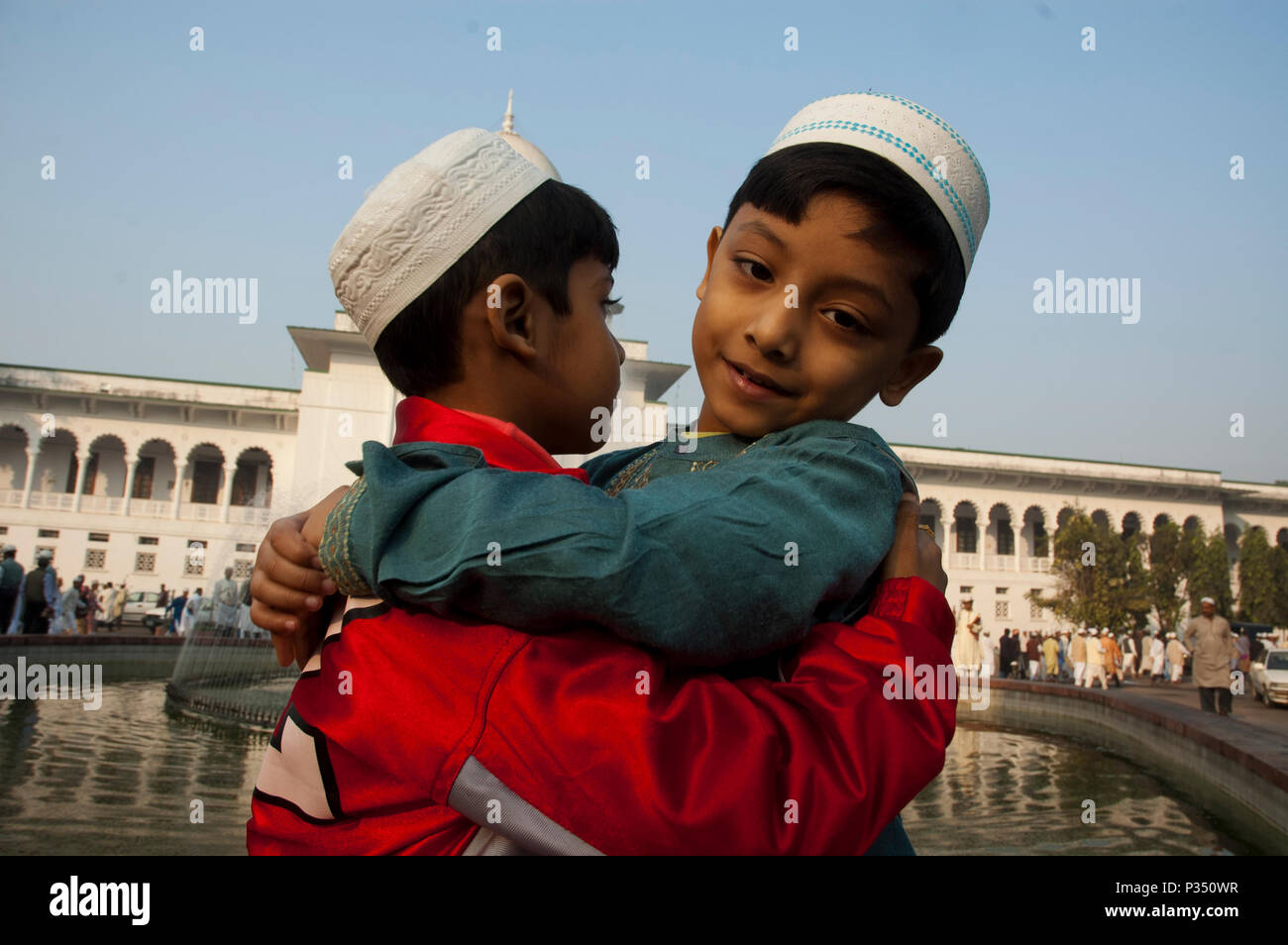 Boys embrace each other after Eid prayers at the National Eidgah Maidan ...