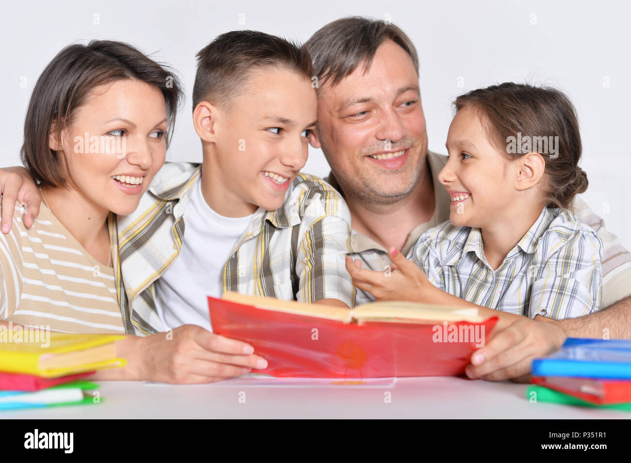 Big happy family doing homework Stock Photo - Alamy