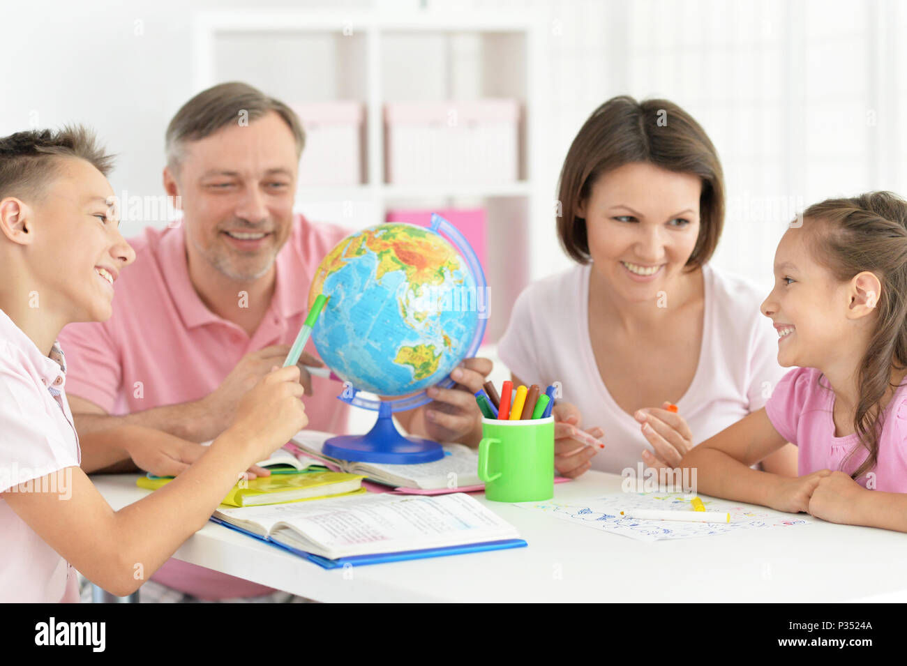 Big happy family doing homework Stock Photo - Alamy