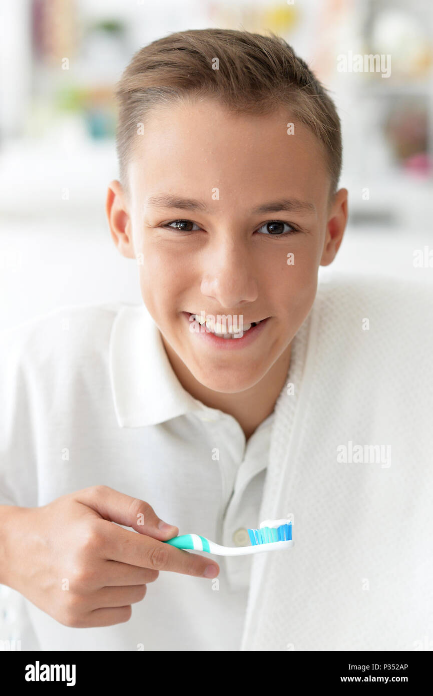 Smiling teen boy brushing teeth Stock Photo - Alamy