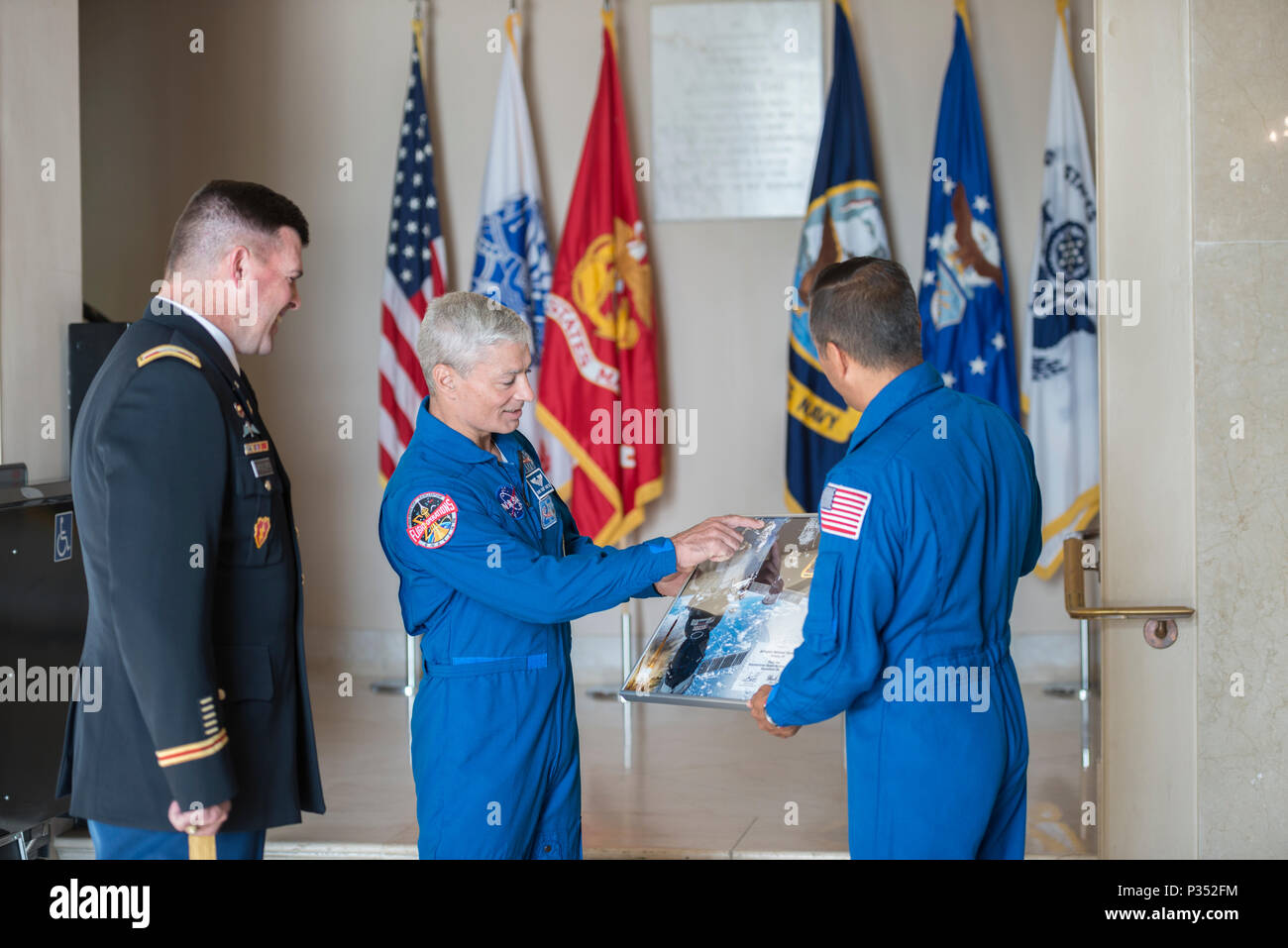 NASA astronauts Mark Vande Hei (center) and Joe Acaba (right) present ...