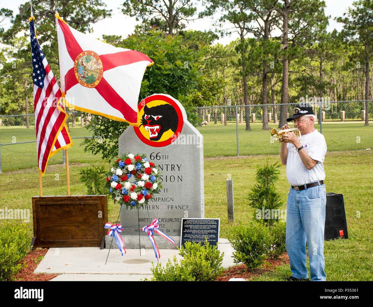 Mr. John Reitz plays the national anthem on his trumpet during the 66th ...