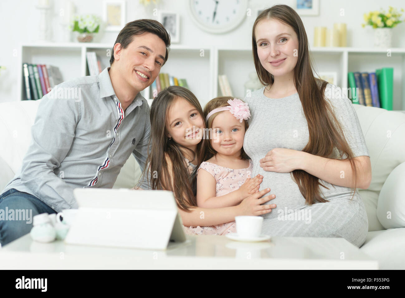 happy pregnant woman with husband and daughters Stock Photo - Alamy