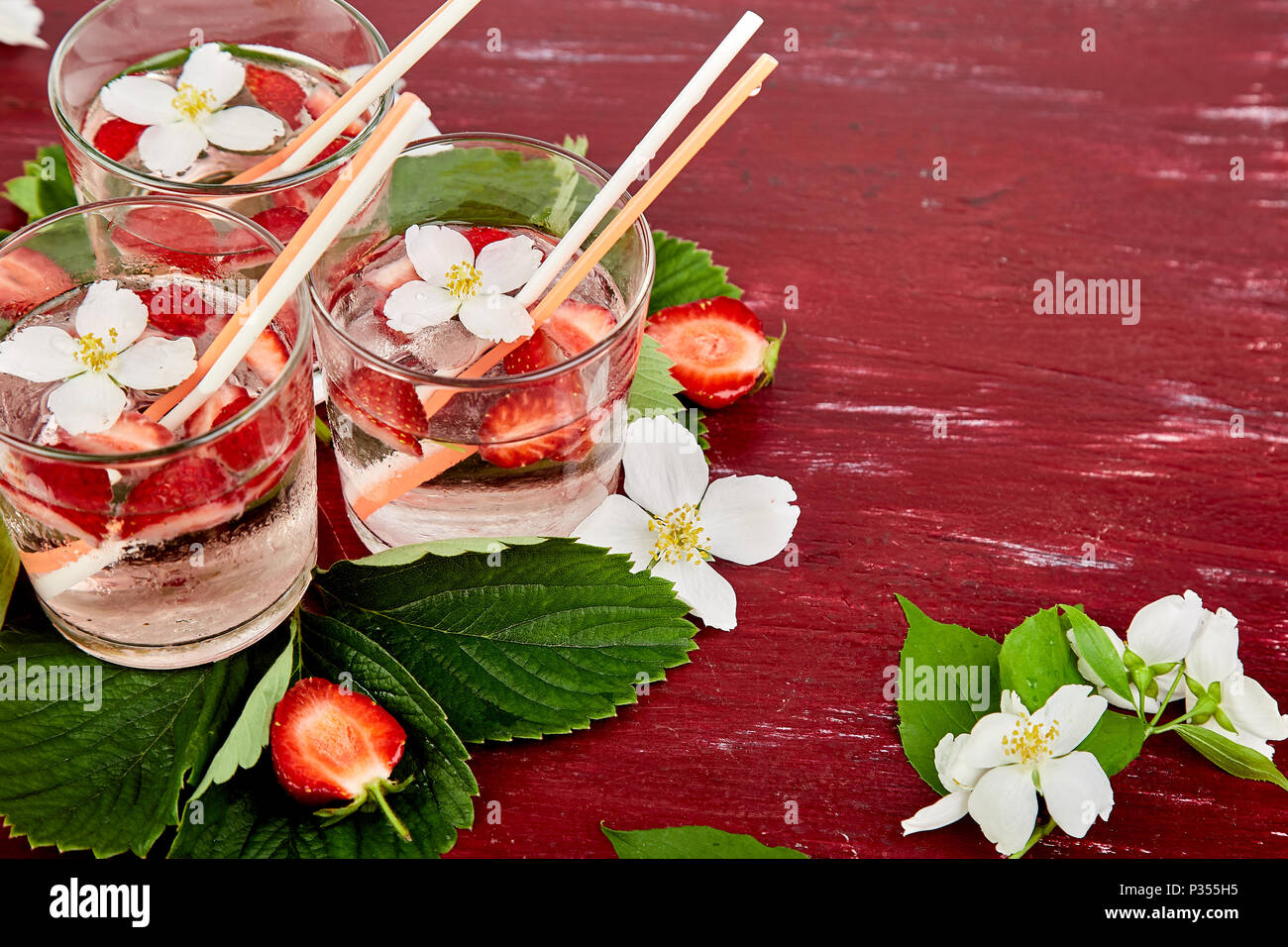 Strawberry detox water with jasmine flower. Summer iced drink or tea ...