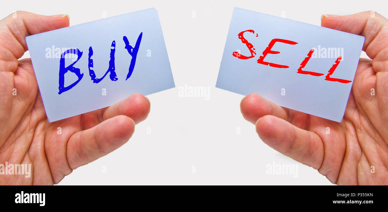 business man hands holding cards with buy sell words Stock Photo - Alamy
