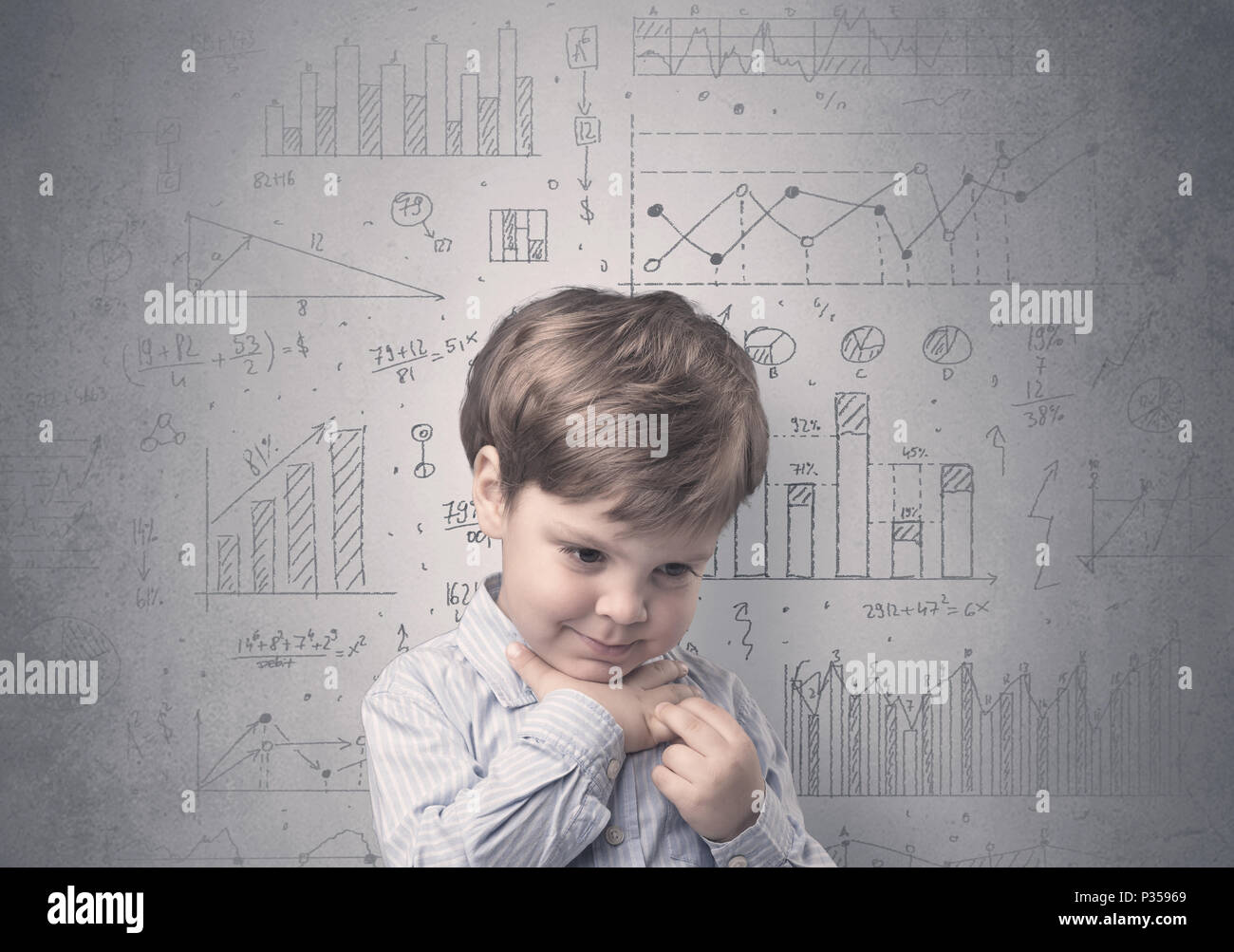 Little boy in front of a grey wall with graphs and statistics around ...