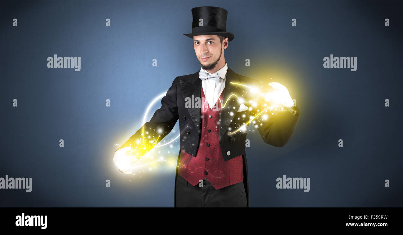 Magician holding his sparkling power between his two hand Stock Photo ...