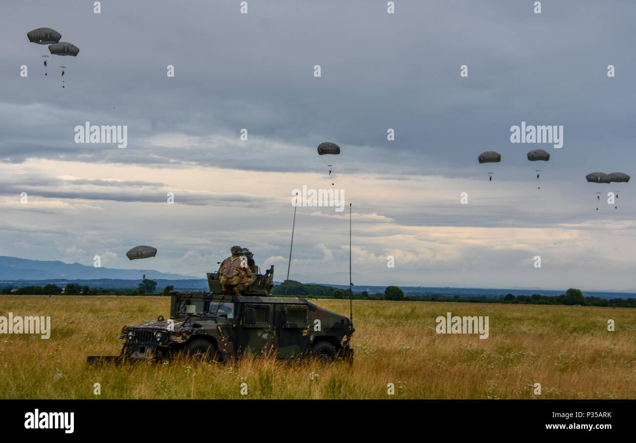 Gun trucks overwatch the drop zone as paratroopers from the 173rd ...