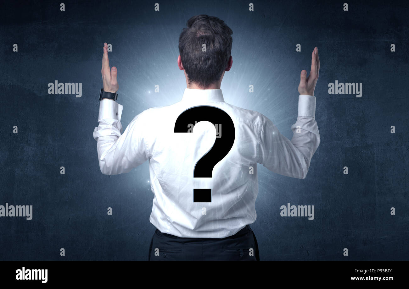 Businessman standing and thinking about questions Stock Photo - Alamy