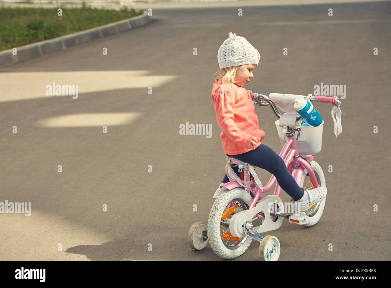 little girl riding a bicycle Stock Photo - Alamy